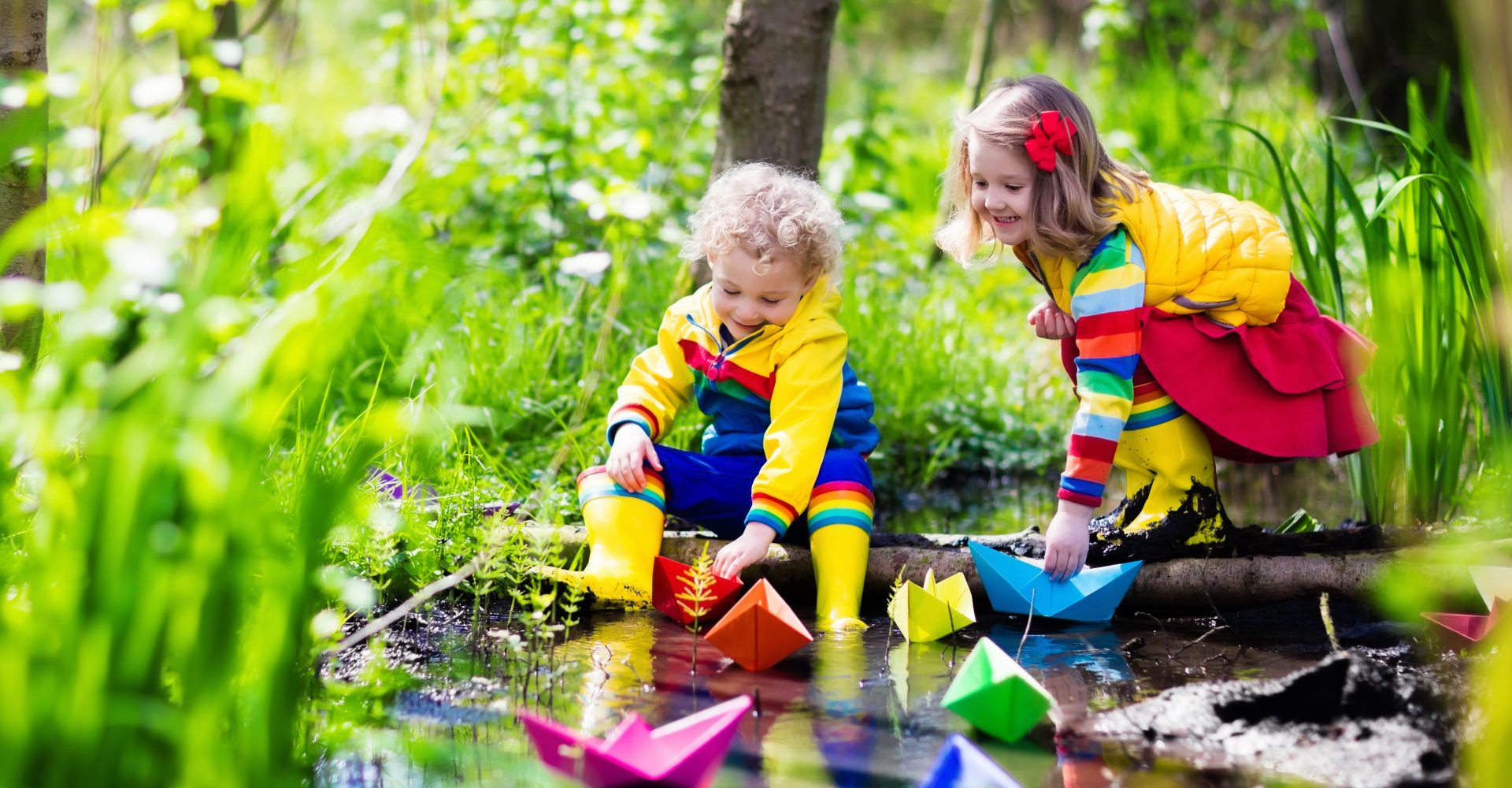 children-play-with-colorful-paper-boats-in-a-small-river-on-a-sunny ...